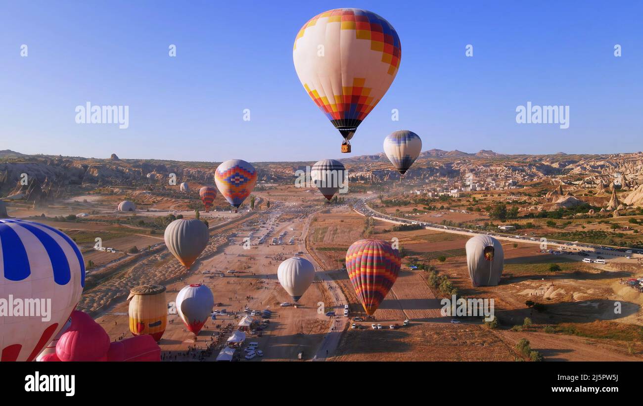 Aerial view of hot air balloons flying at sunrise in Cappadocia, Turkey ...