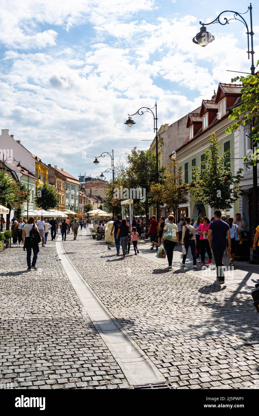 People and tourists wandering on the streets of old town Sibiu, Romania ...