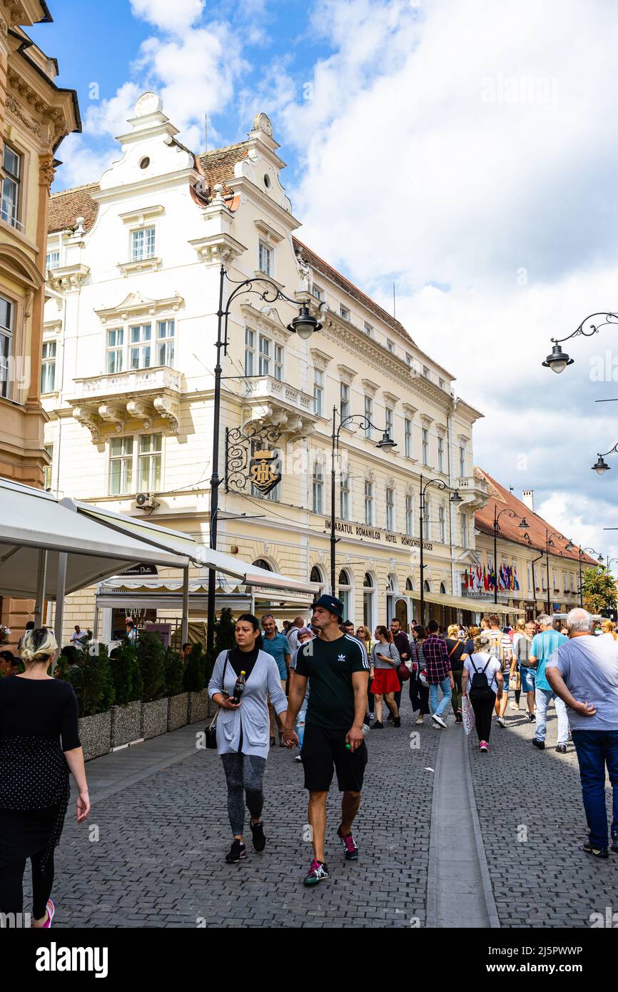 People and tourists wandering on the streets of old town Sibiu, Romania ...
