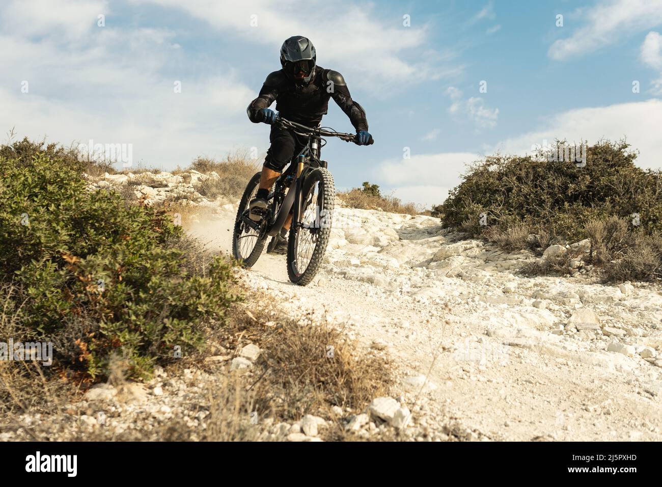 Rider Fully Equipped With Protective Gear During Downhill Ride On His