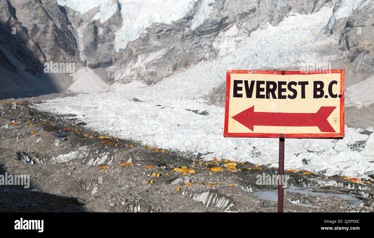 View from Mount Everest base camp, tents and prayer flags and signpost ...