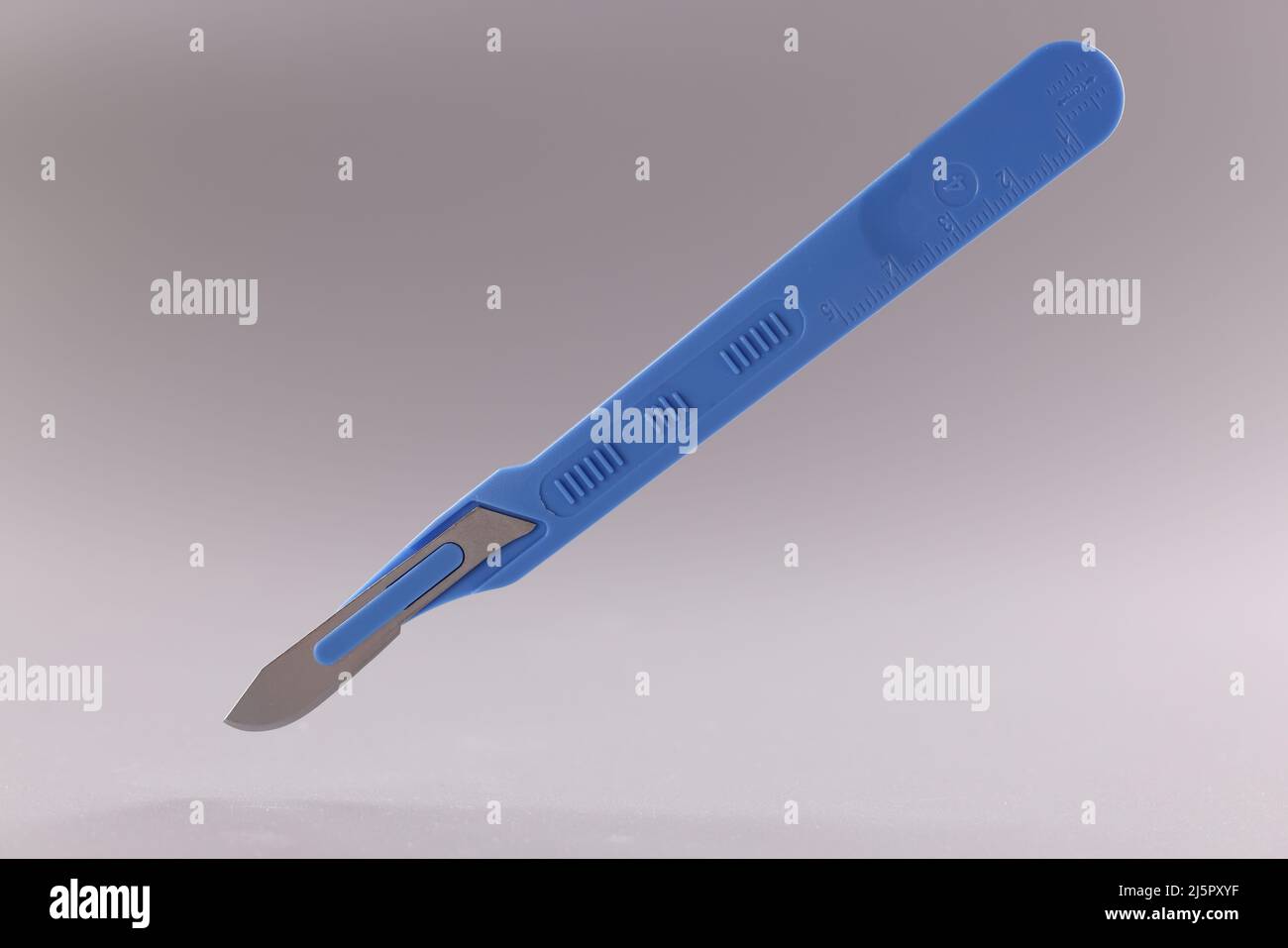 Scalpel, surgical stainless steel metal instrument on grey background ...