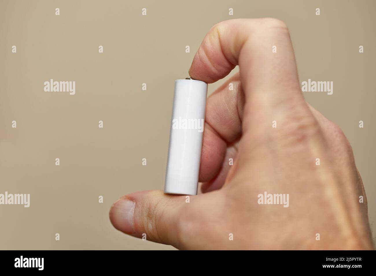 1.5 Volt AA Battery in hand Stock Photo - Alamy