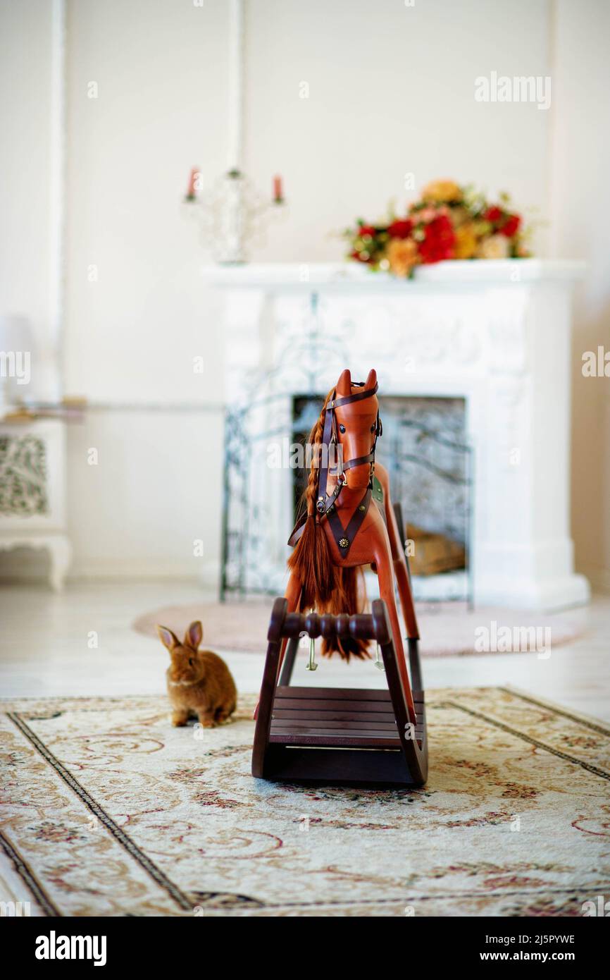 Rocking horse with rabbit in a house at daytime Stock Photo - Alamy