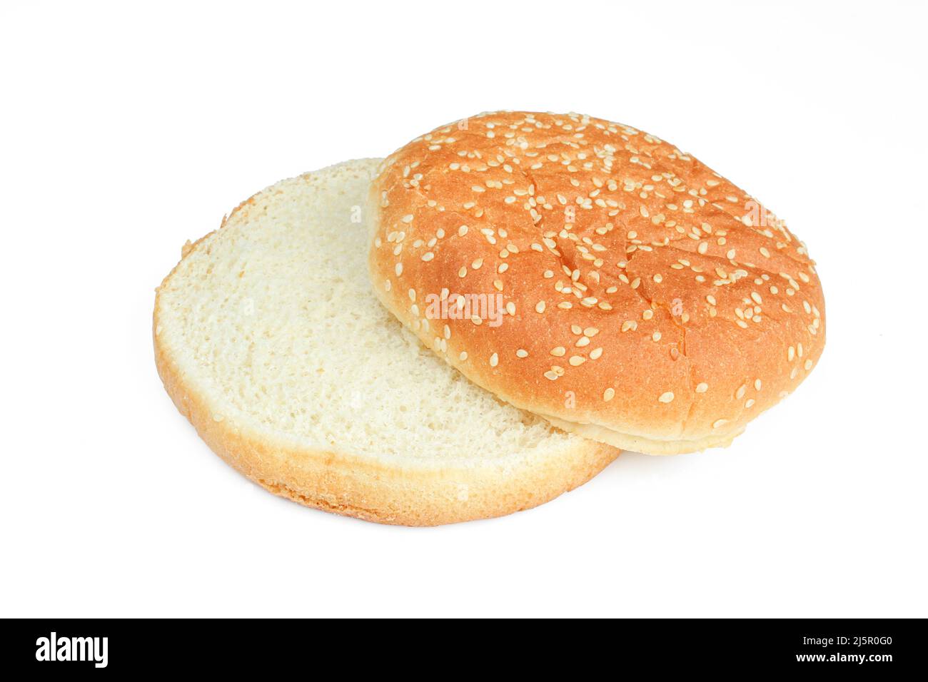 Two parts of sliced burger bun with sesame isolated on white background ...
