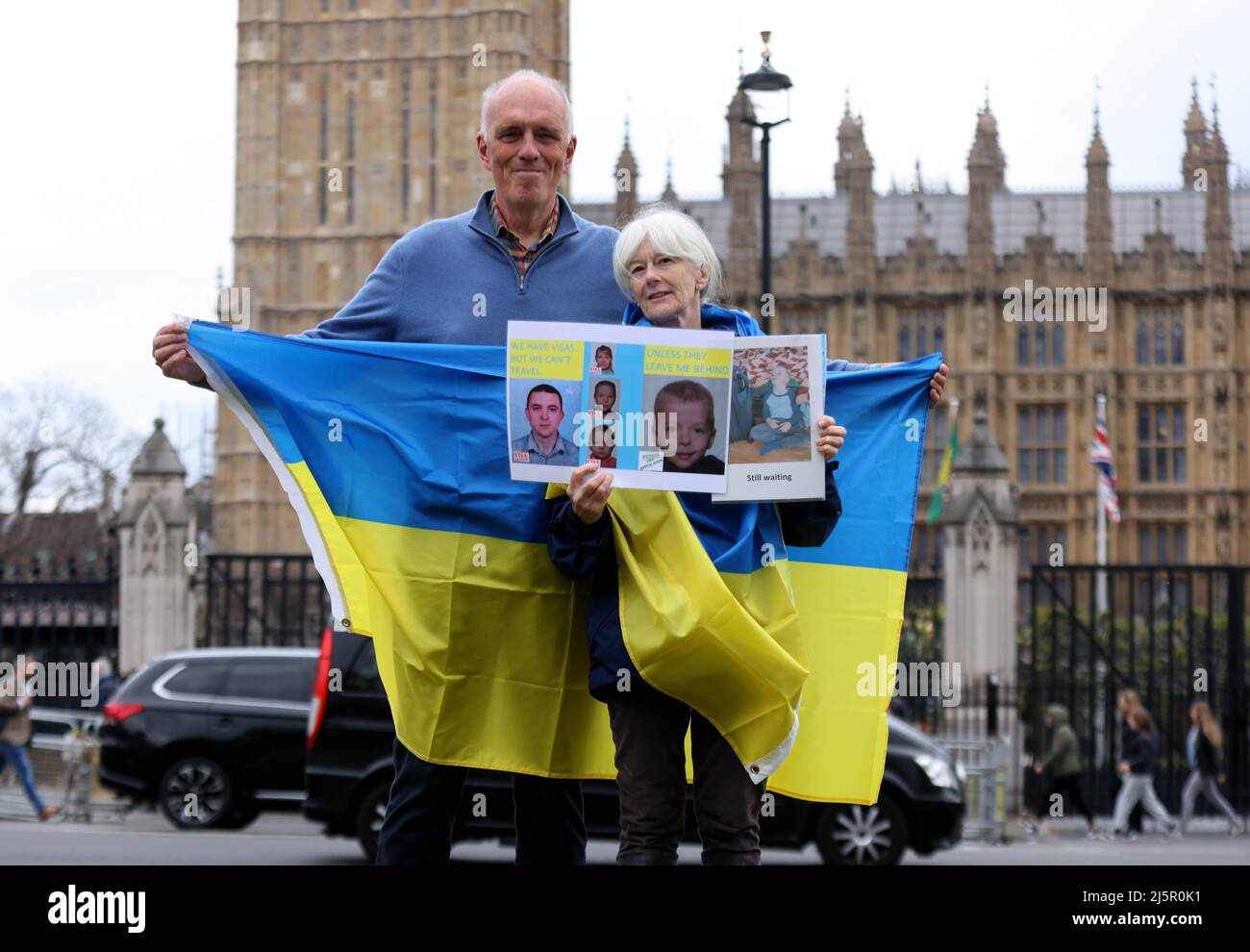 Trevor and Debbie Farnfield, pose for a photo holding a Ukrainian flag ...