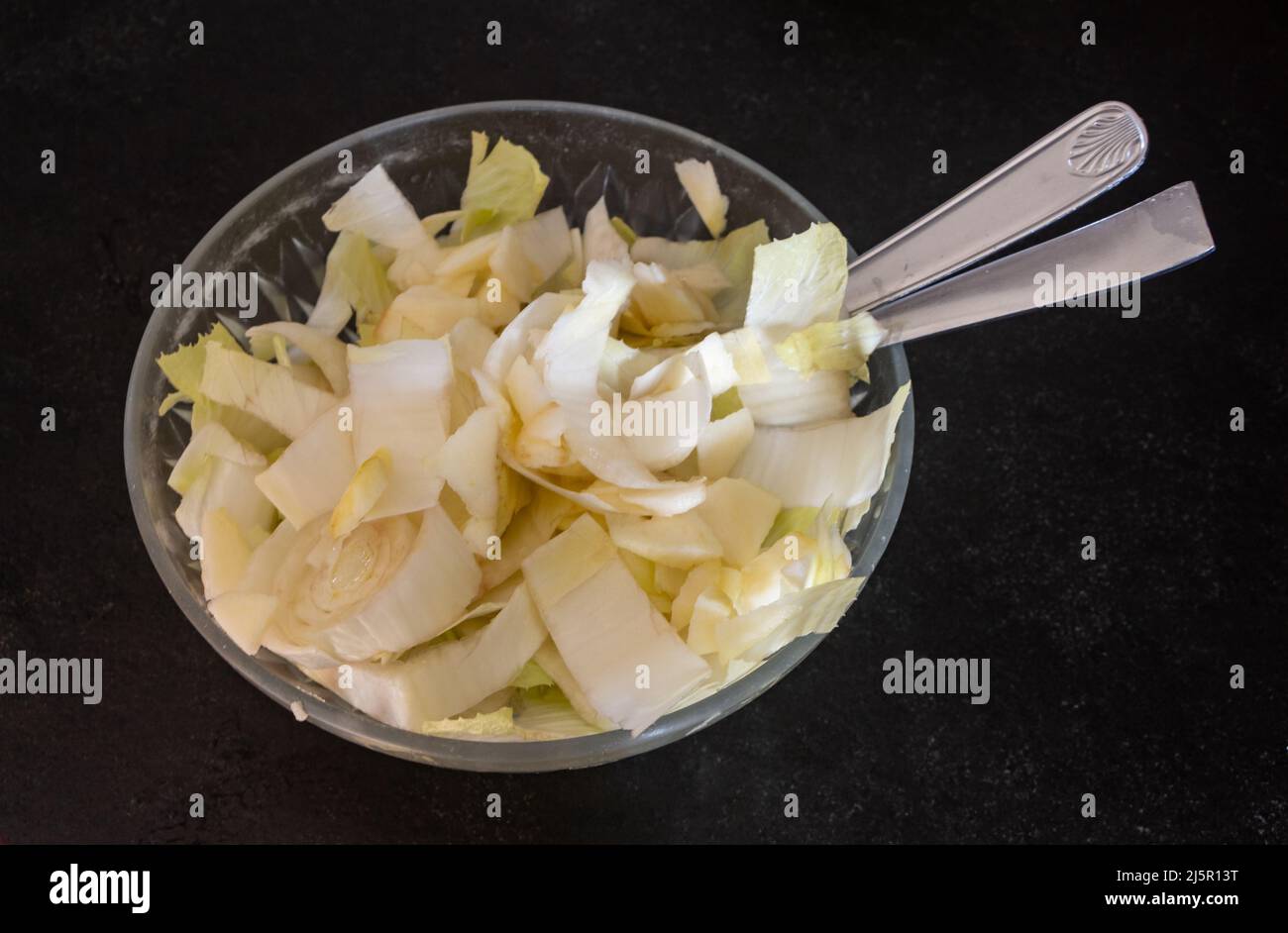 Chopped endive with apple pieces as appetizer Stock Photo - Alamy