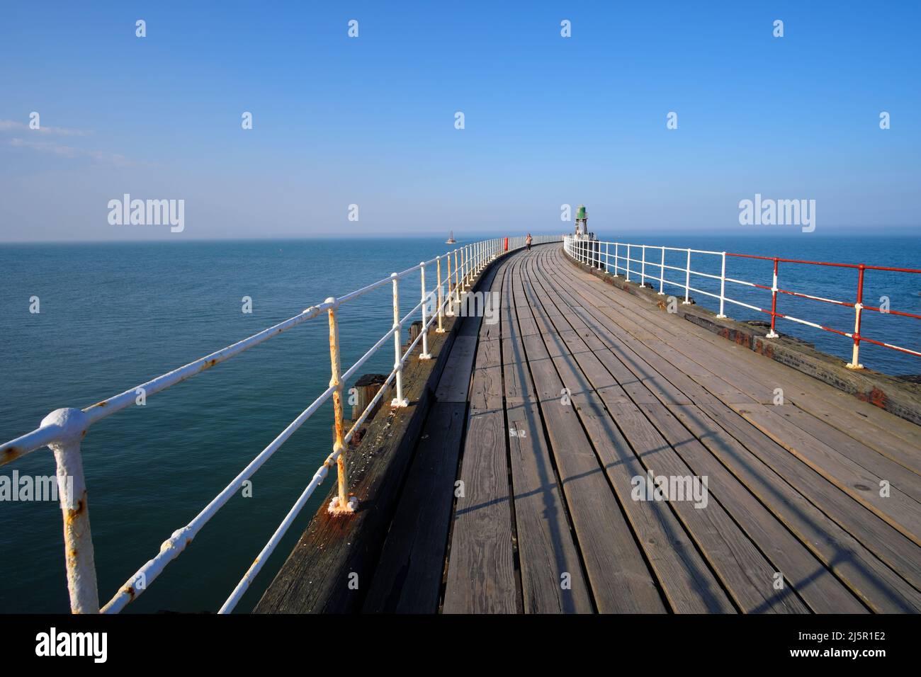 The boardwalk to the lighthouse on Whitby's outer harbour in Whitby ...