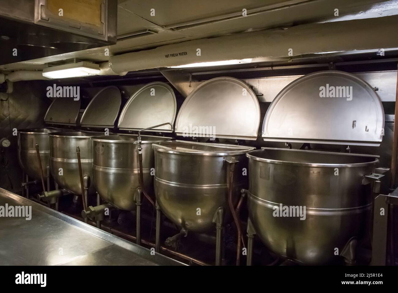 Five identical retro washing machines in the laundry room of the USS ...