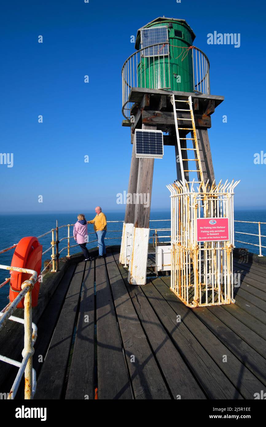 The lighthouse at the end of the boardwalk on Whitby's outer harbour in ...
