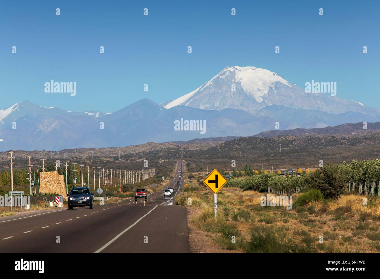 Highway through Argentinian Uco valley with the snowy Andes mountains ...