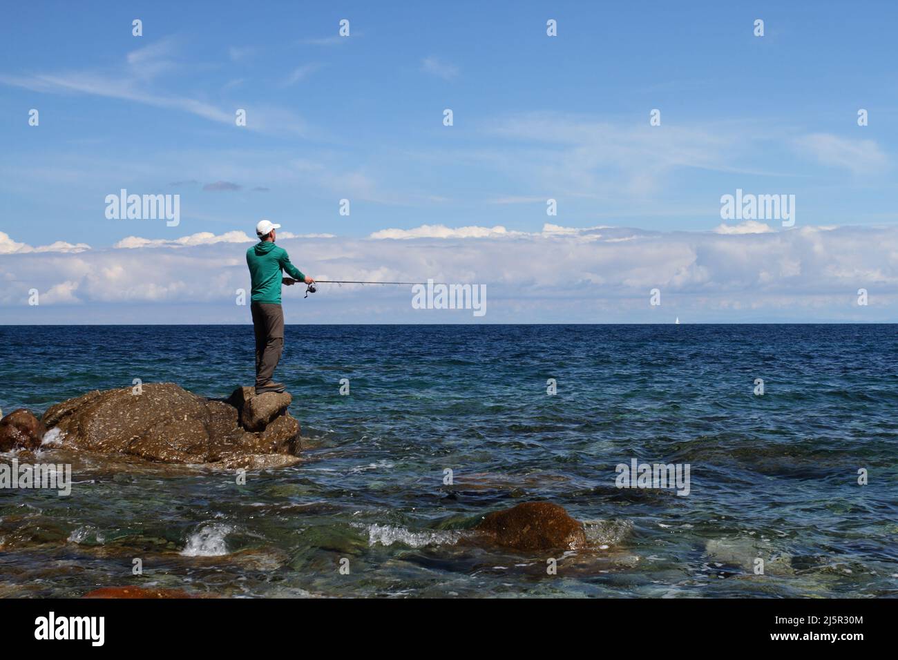Angler man fishing from beach hi-res stock photography and images - Alamy