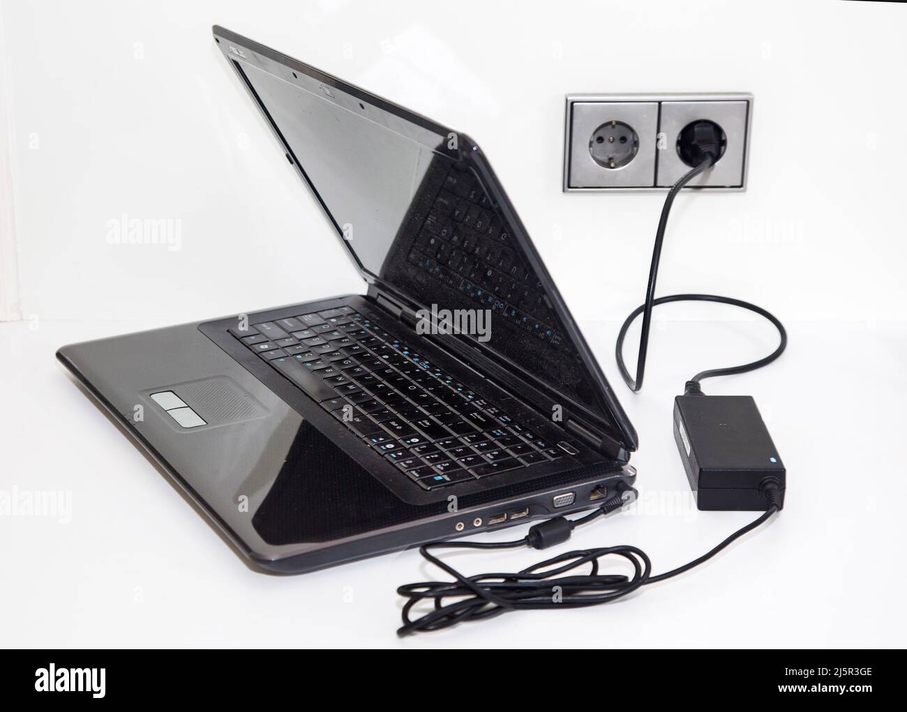 Charging a laptop Stock Photo - Alamy