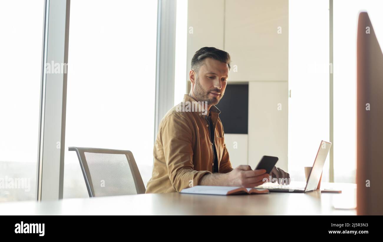 Businessman texting office desk hi-res stock photography and images - Alamy