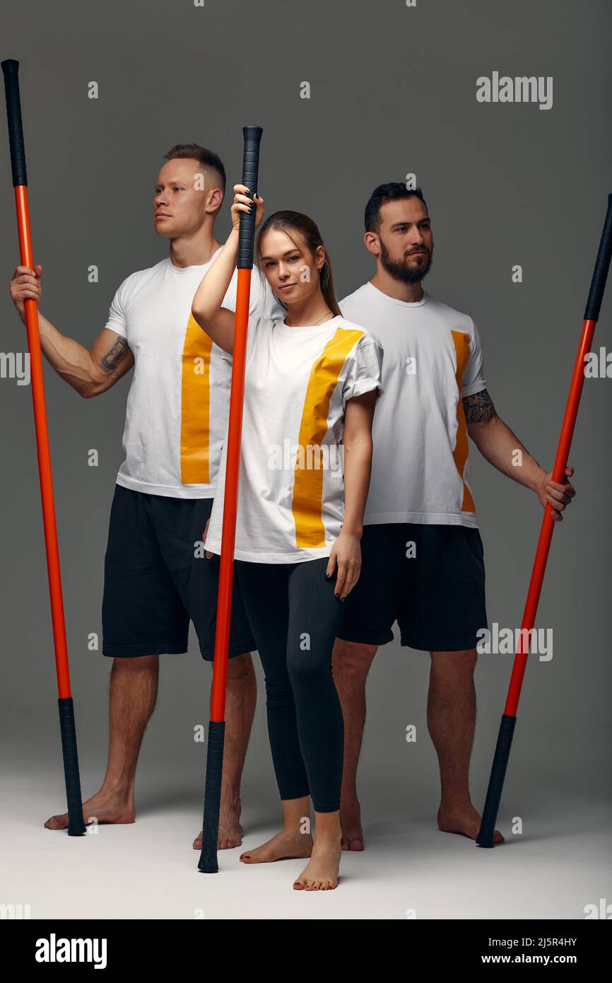 People stand together and practice sticks. Karate masters posing with ...