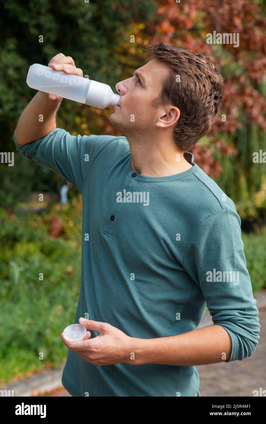 Young man drinking water from a 'Dopper' bottle Stock Photo - Alamy