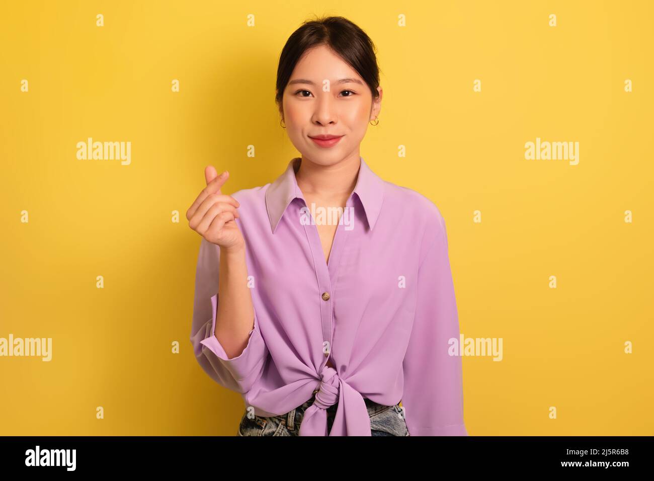 Saranghae. Beautiful young Asian woman making Korean finger mini heart ...