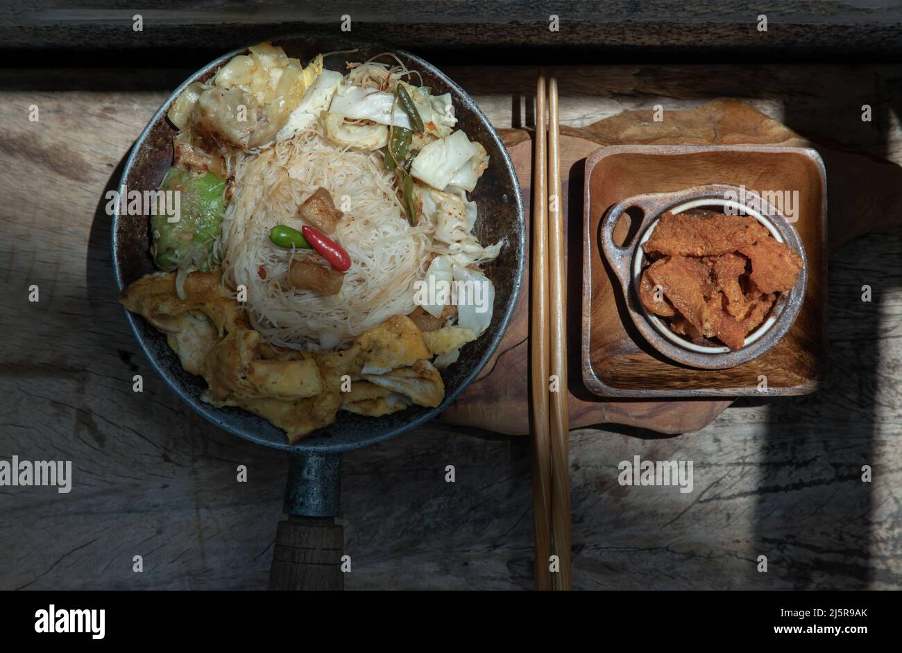 Stir fried rice vermicelli with pork dumplings, egg and vegetable in ...