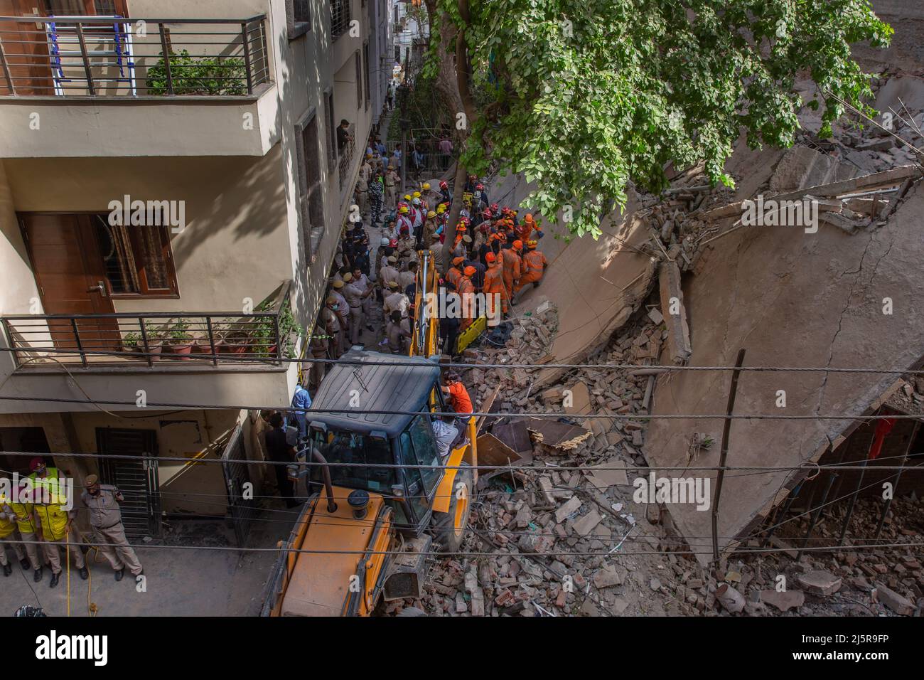 New Delhi, India. 25th Apr, 2022. Rescuers remove debris to search for ...