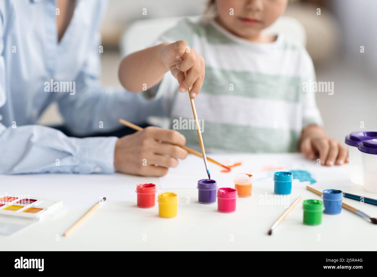 Art development for kids. Unrecognizable little boy painting with ...