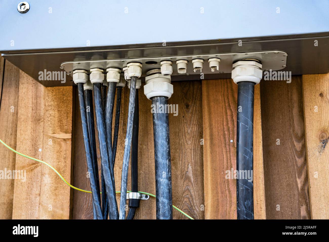 electrical panels and electrical cables connected to them on the wall ...