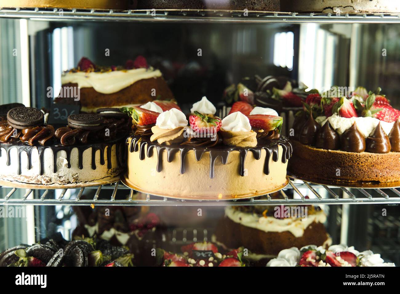 glass showcase with different cakes Stock Photo - Alamy