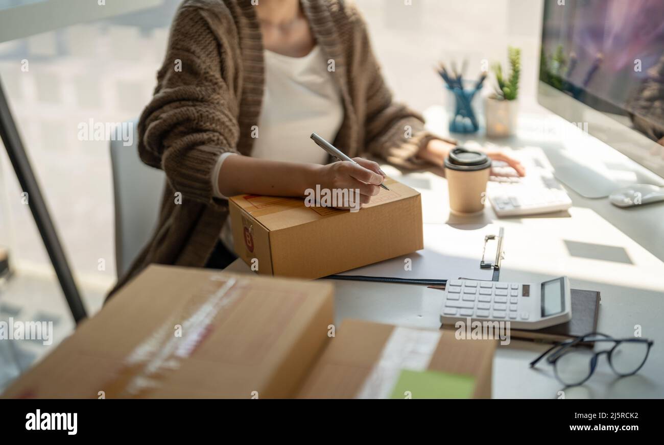 Online sales business woman owner is taking note of the customer's ...