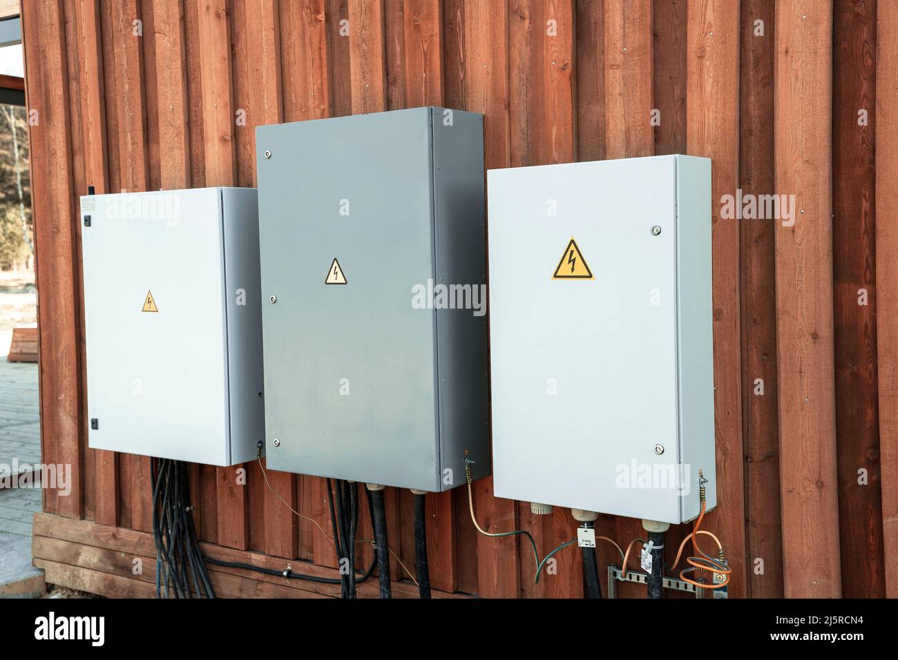 electrical panels and electrical cables connected to them on the wall ...