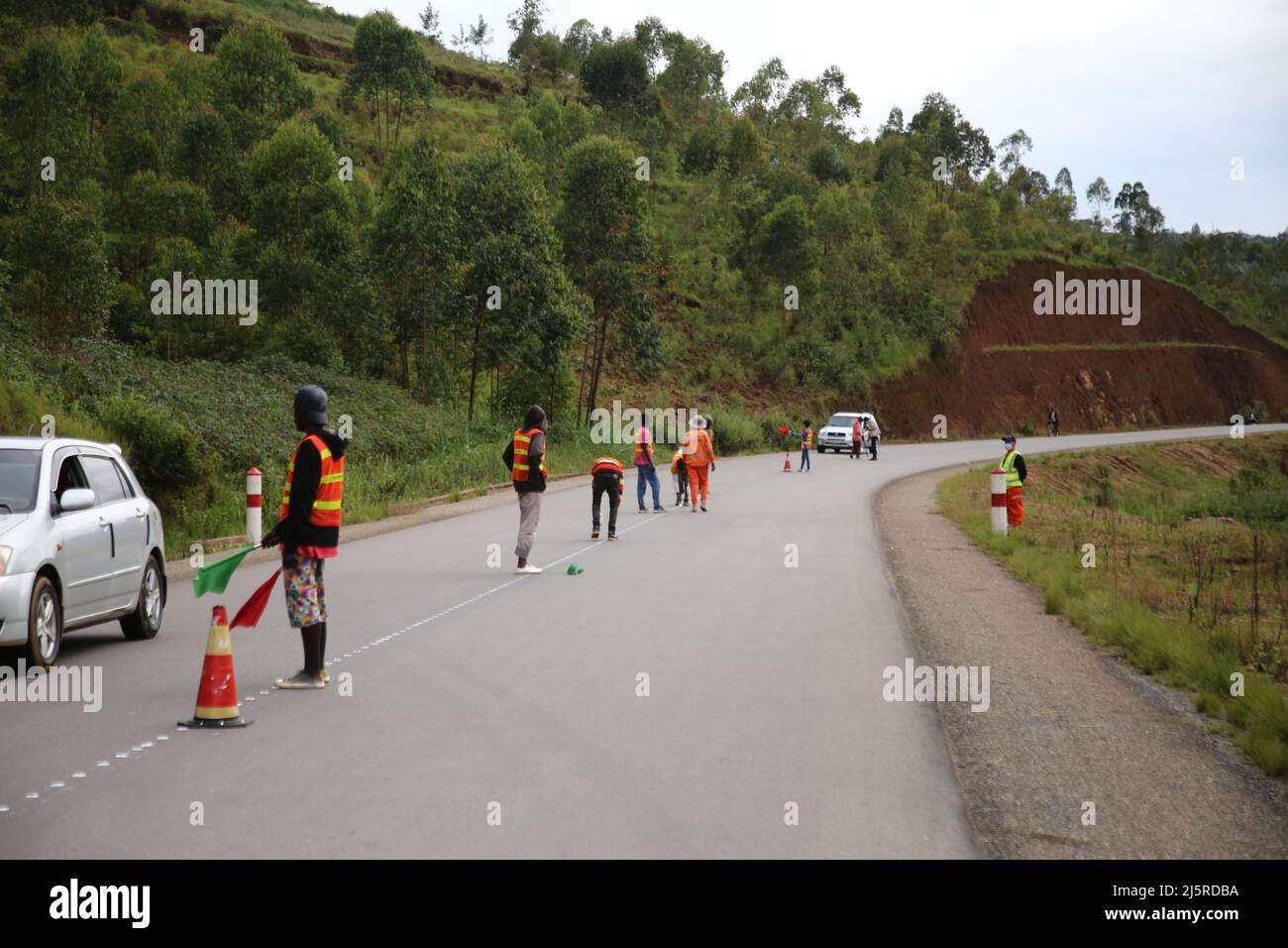 Huye. 21st Apr, 2022. Workers mark a line on the road from Huye to ...
