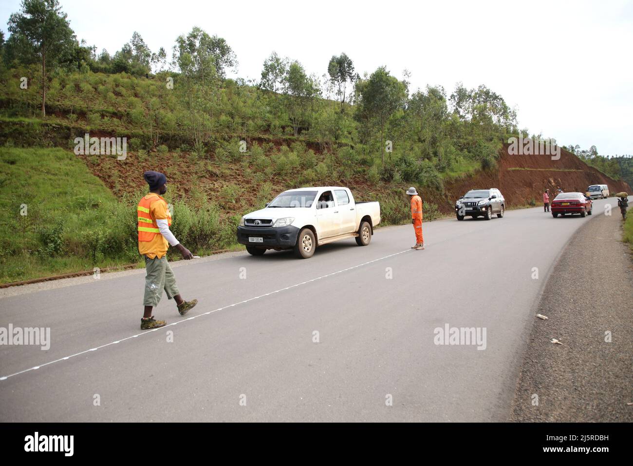 Huye. 21st Apr, 2022. Workers mark a line on the road from Huye to ...