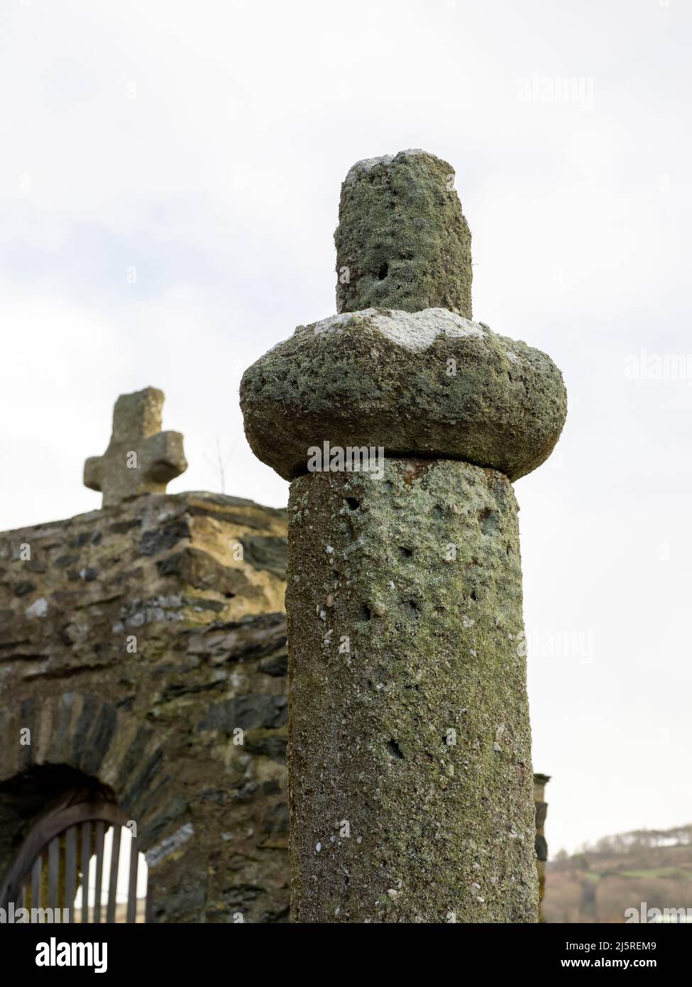 An ancient stone cross in the churchyard at Llanelian near Point Lynas ...