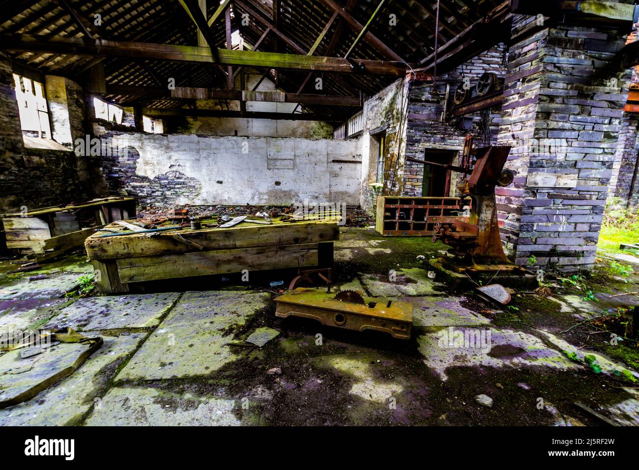 Maintenance workshop of old slate quarry in Wales. Old rusty tools and ...