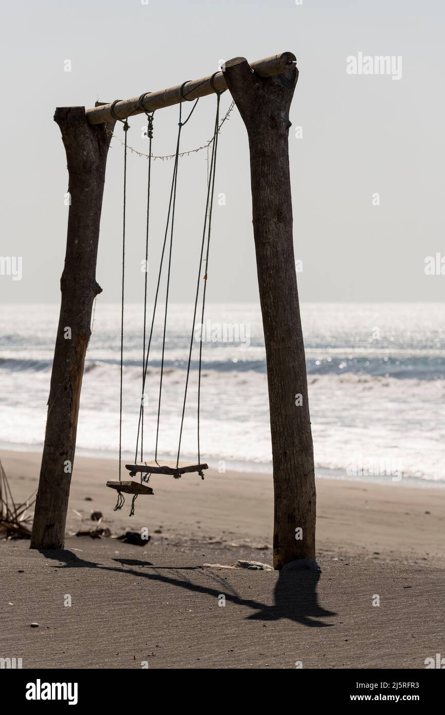 Wooden swing with ropes overlooking the sea. Swing on seashore ...