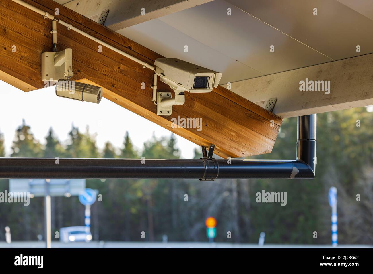 Technological view of security surveillance camera under roof of house ...