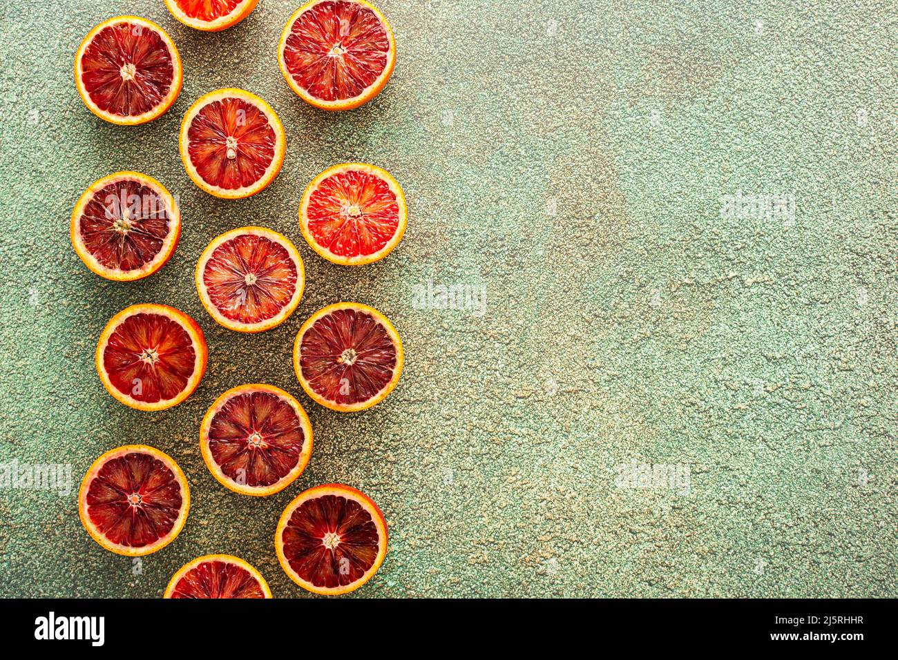 Half cut blood orange halves on a green background, top view Stock ...