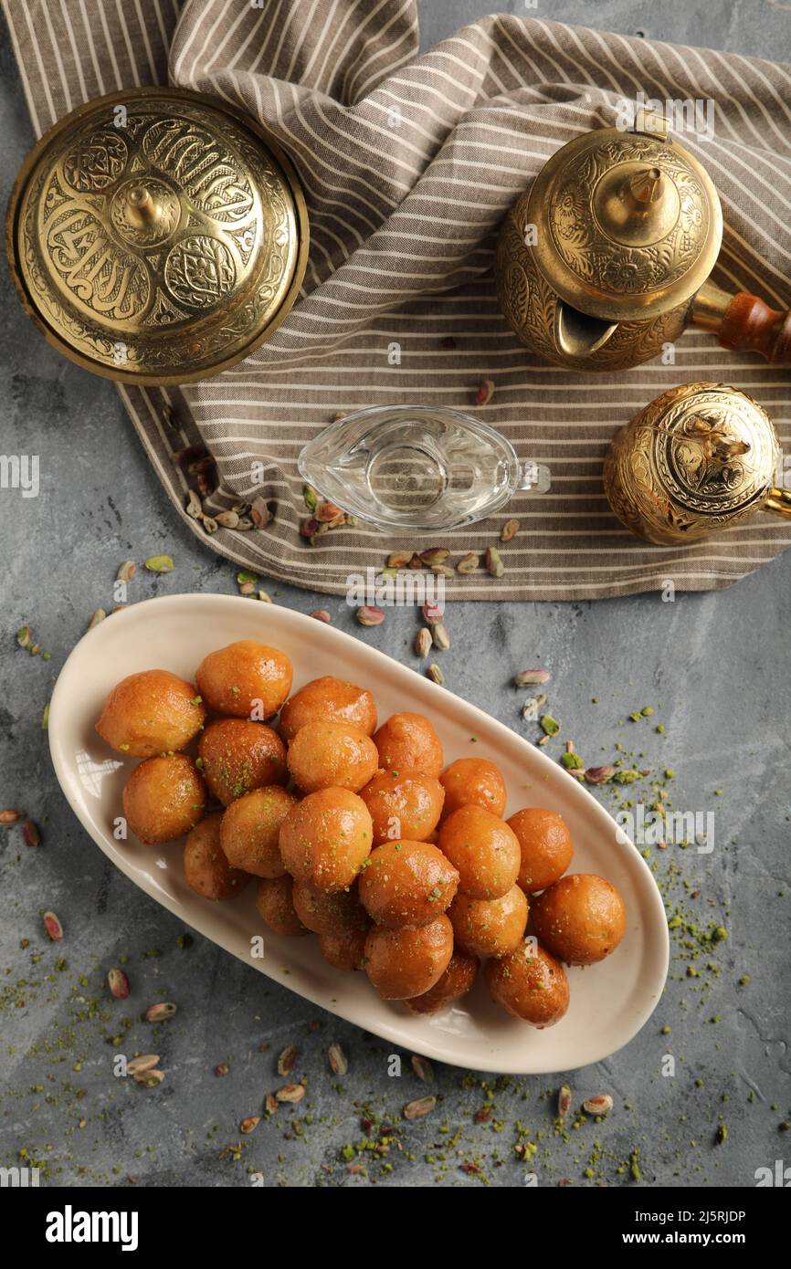 luqaimat or lokma. Freshly fried Lokma (luqma - arabic) piled high a ...