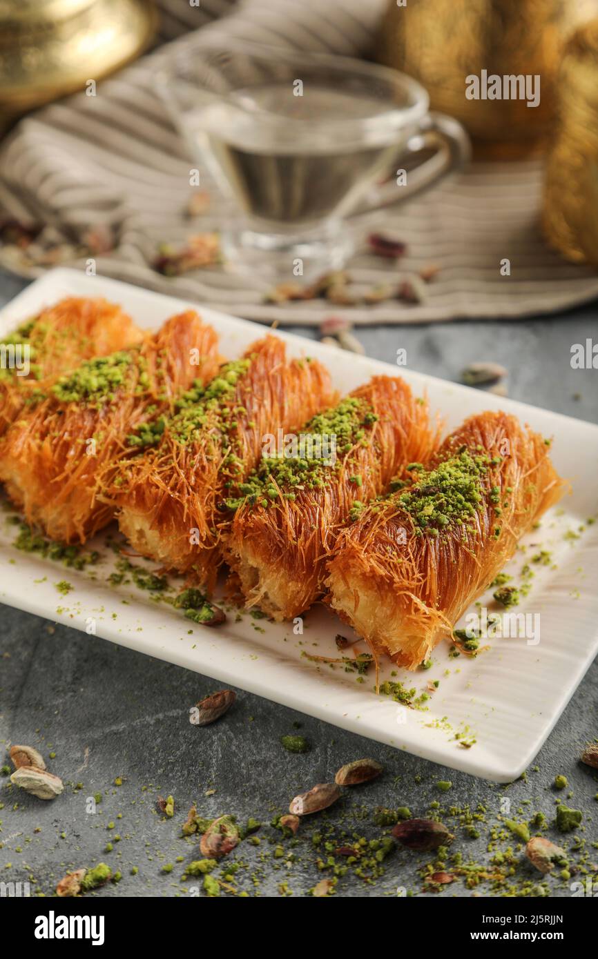 Homemade arabian traditional sweets Kunafa or konafa roll with cheese ...