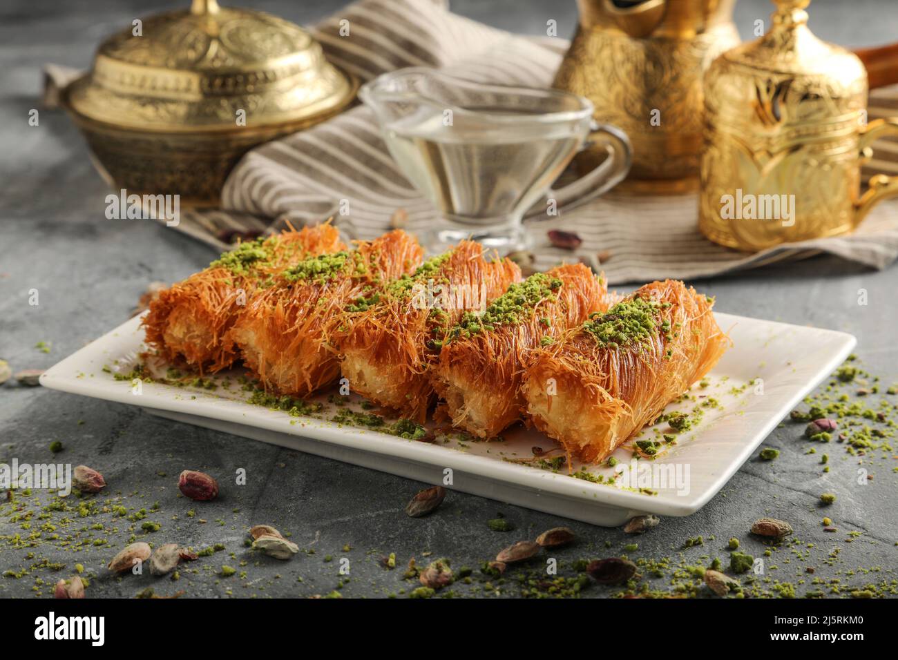 Homemade arabian traditional sweets Kunafa or konafa roll with cheese ...