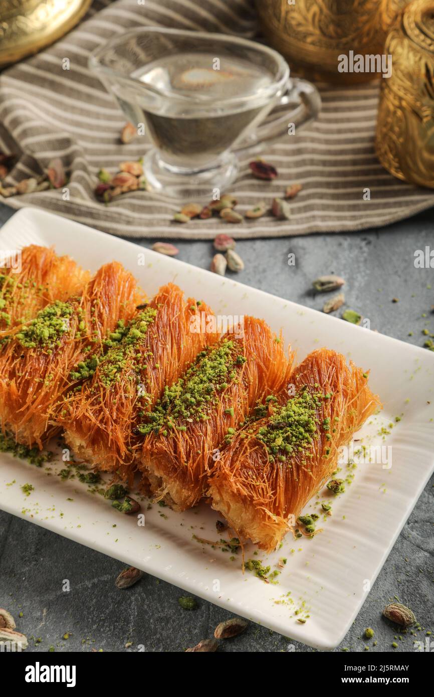 Homemade arabian traditional sweets Kunafa or konafa roll with cheese ...