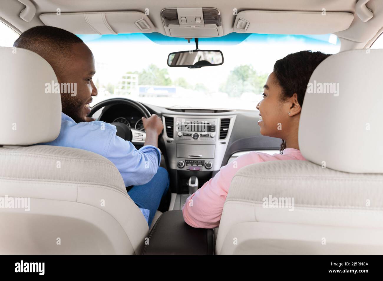 Happy black couple enjoying drive on new car Stock Photo - Alamy