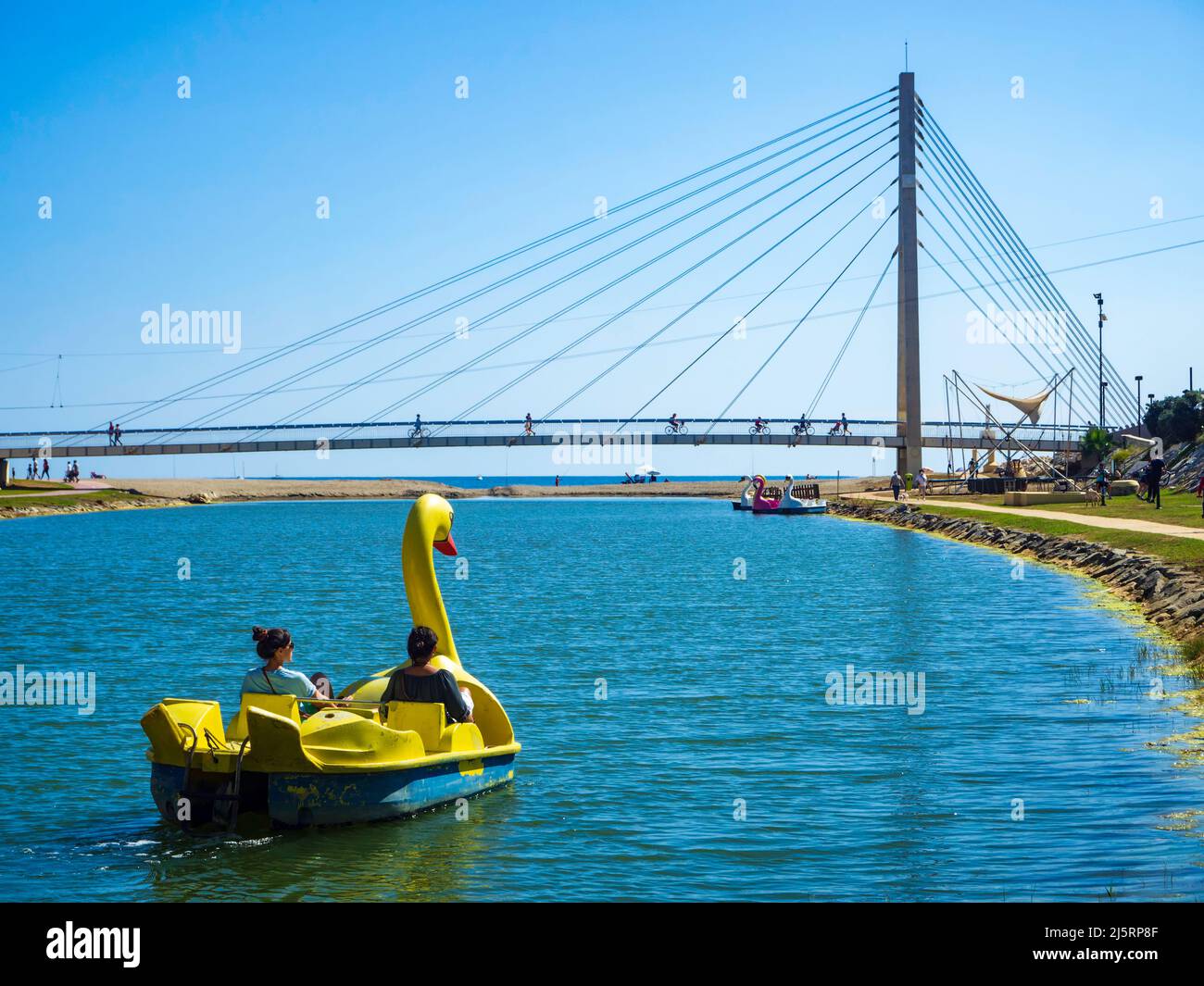 Two young girls riding a pedalino on the river Fuengirola with the ...