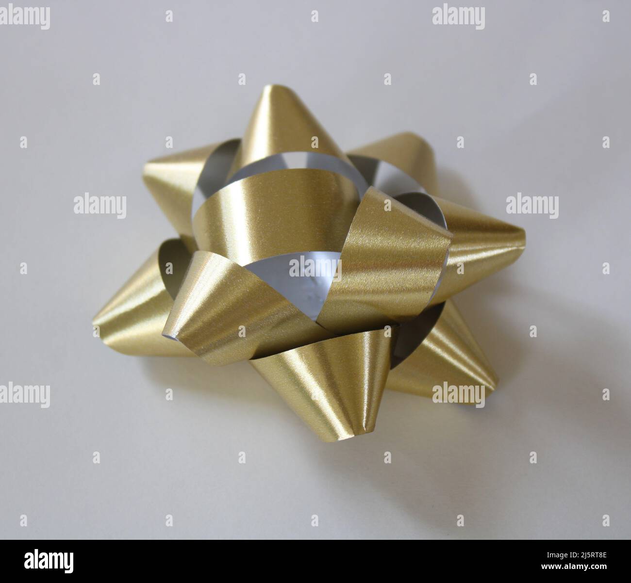 A Common Gold Gift Bow on a White Background Stock Photo - Alamy