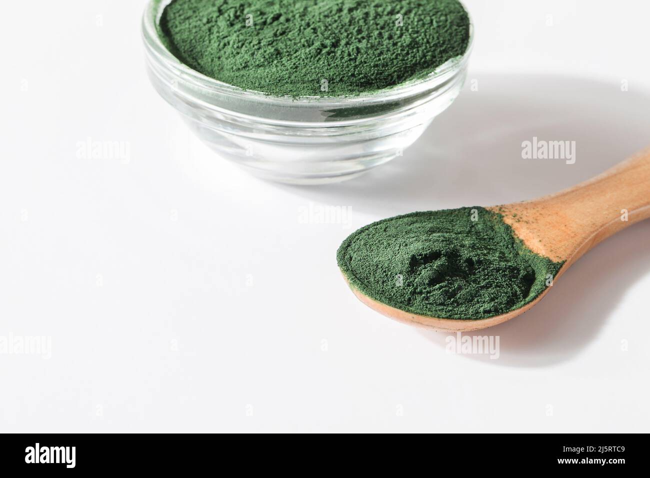 natural additives and superfood. green spirulina algae powder in glass ...