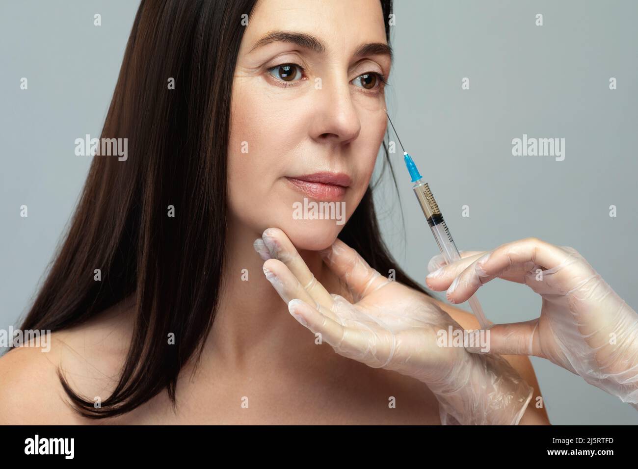 Middle aged woman receiving facial injection for skin rejuvenation ...