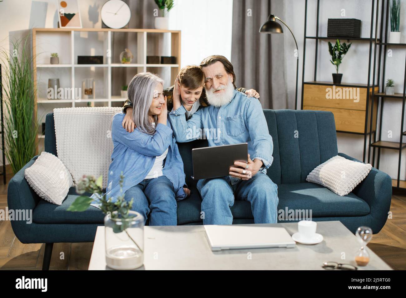 Relaxed caucasian grandson grandpa embrace together and grandma in ...