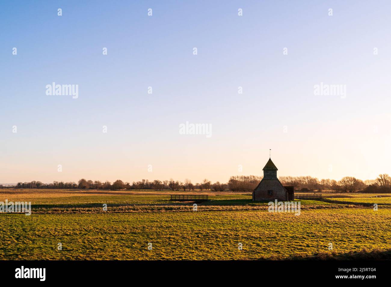 Distant view of the lonely 13th century church of St Thomas a Becket on ...