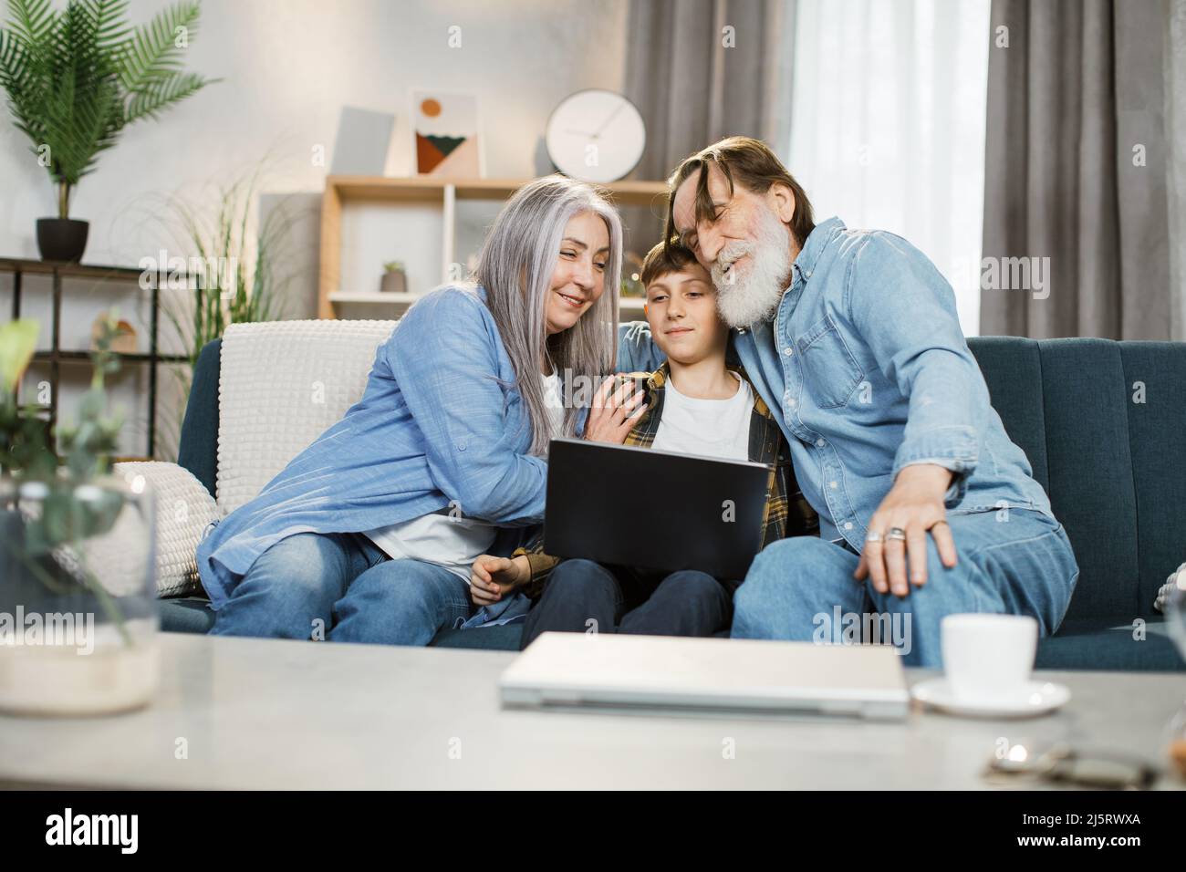 Happy family of grandparents and their grandson boy having fun together ...