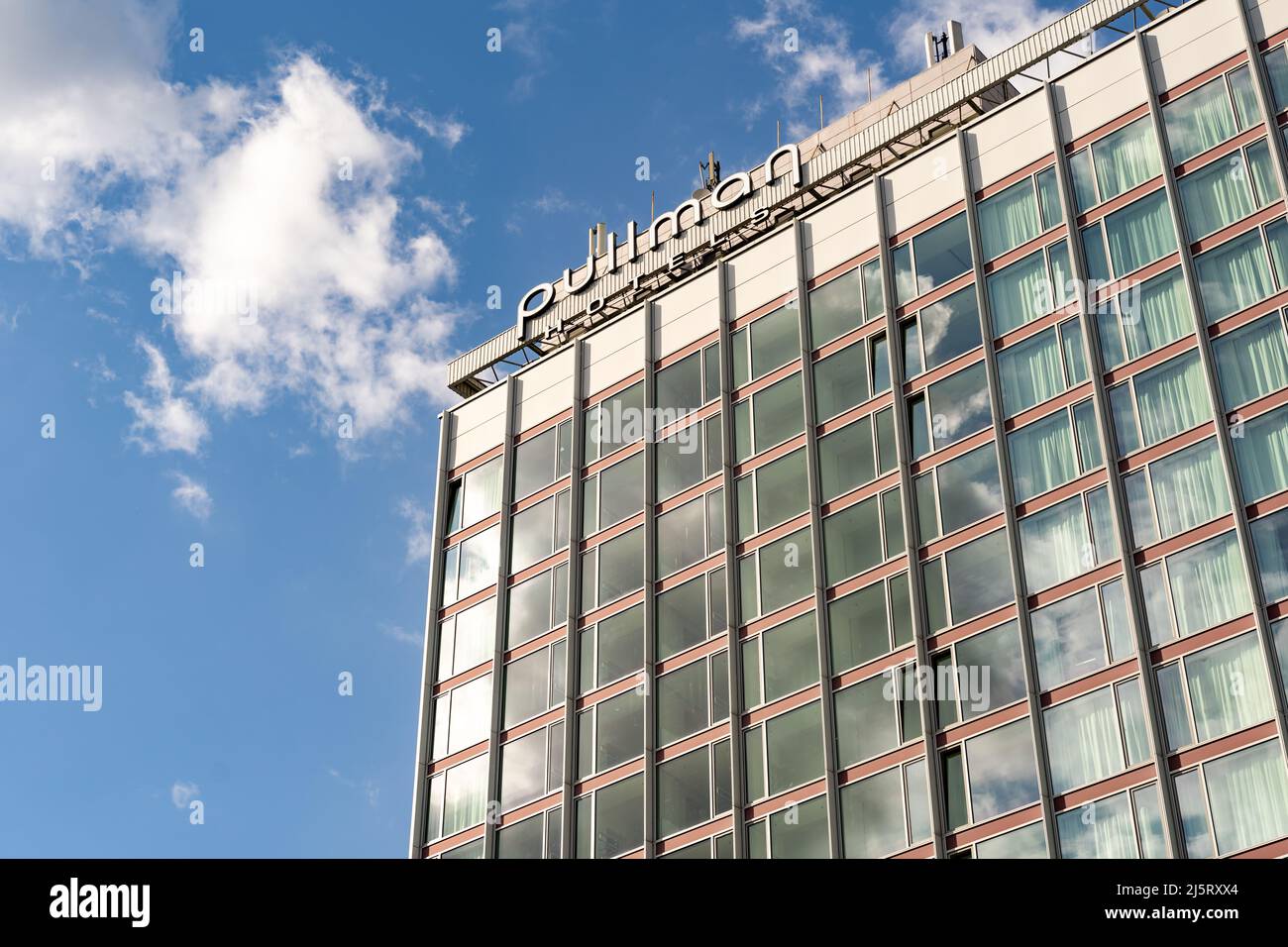 Facade of the Pullman Hotel in front of the blue sky. Building exterior ...