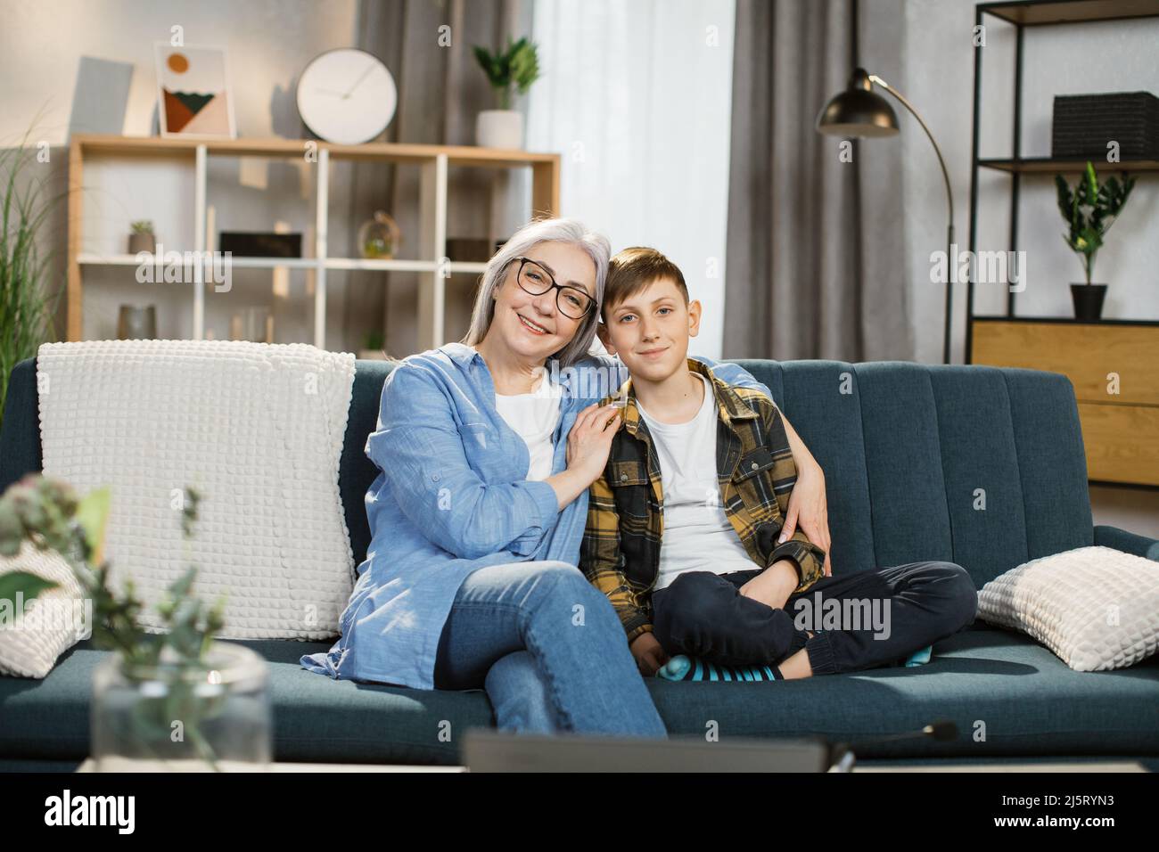 Portrait of a grandmother with her grandson, an old woman sits on the ...
