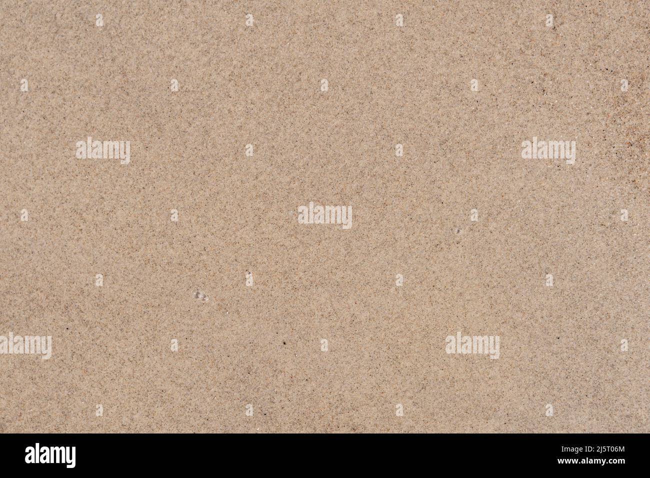 Wet sand on a beach. Top down view of an idyllic holiday scene. Natural ...